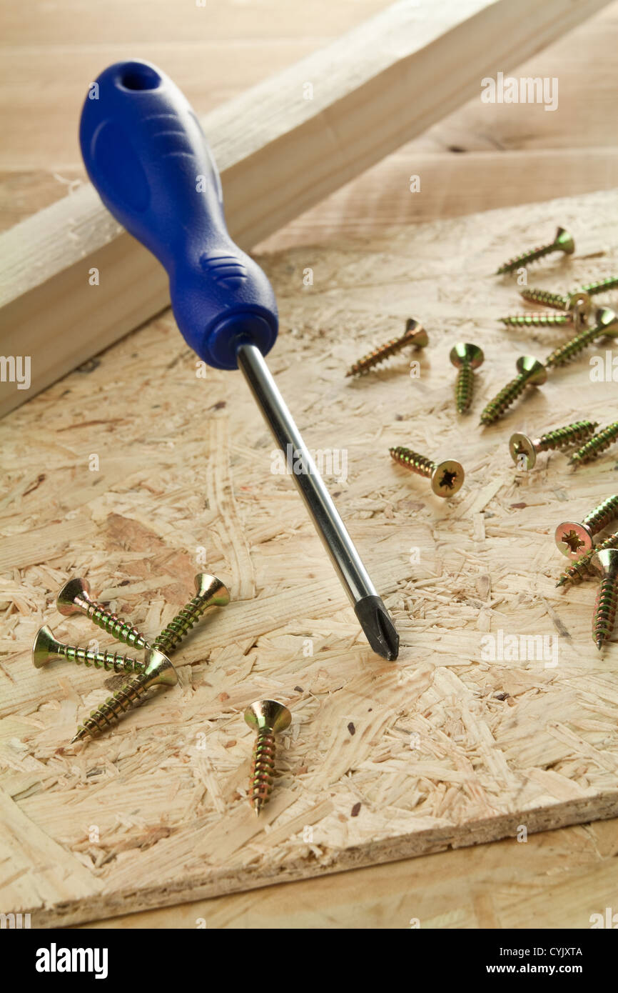 Wood workshop. Screwdriver and screws Stock Photo - Alamy