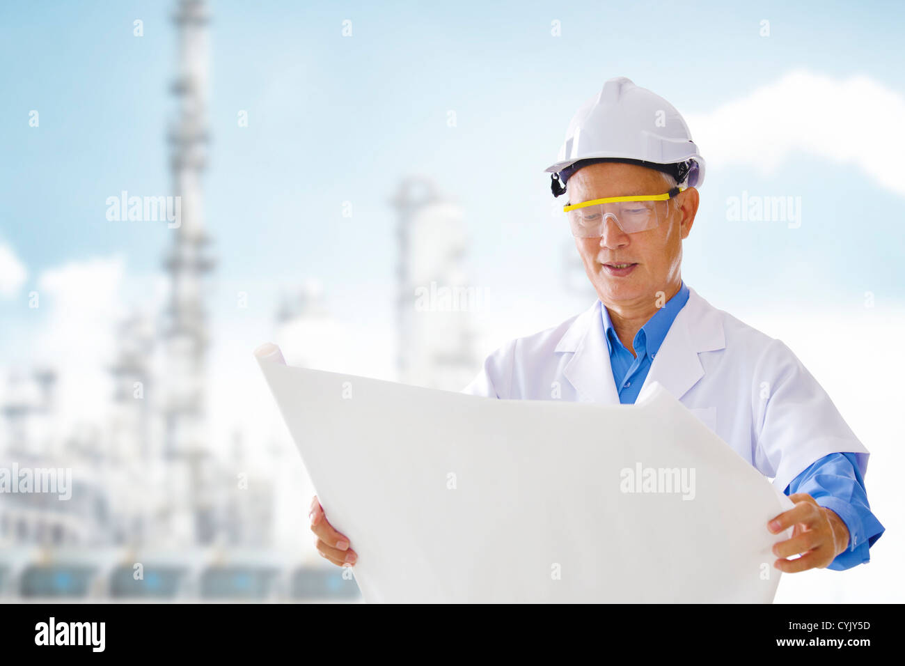 Senior Asian engineer with blueprints standing outside plant Stock ...