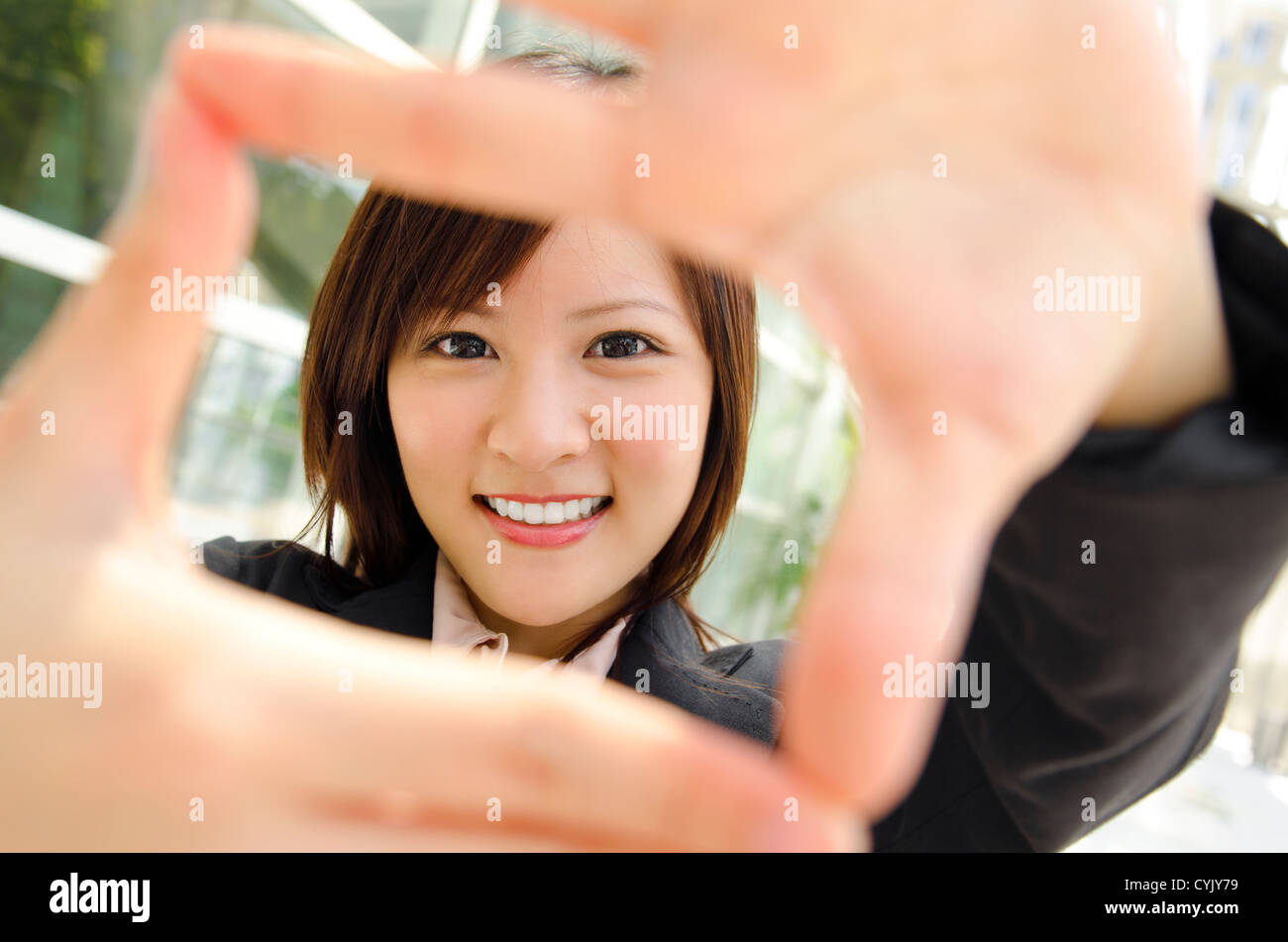 Smiling Asian business woman making a frame with fingers Stock Photo ...