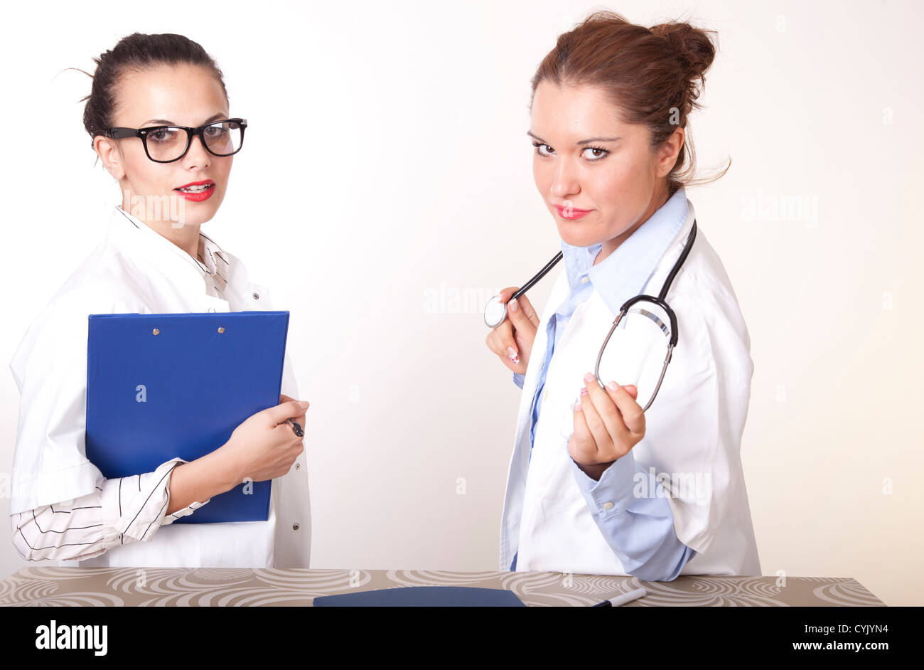 Portrait of a two young beautiful female doctors Stock Photo - Alamy