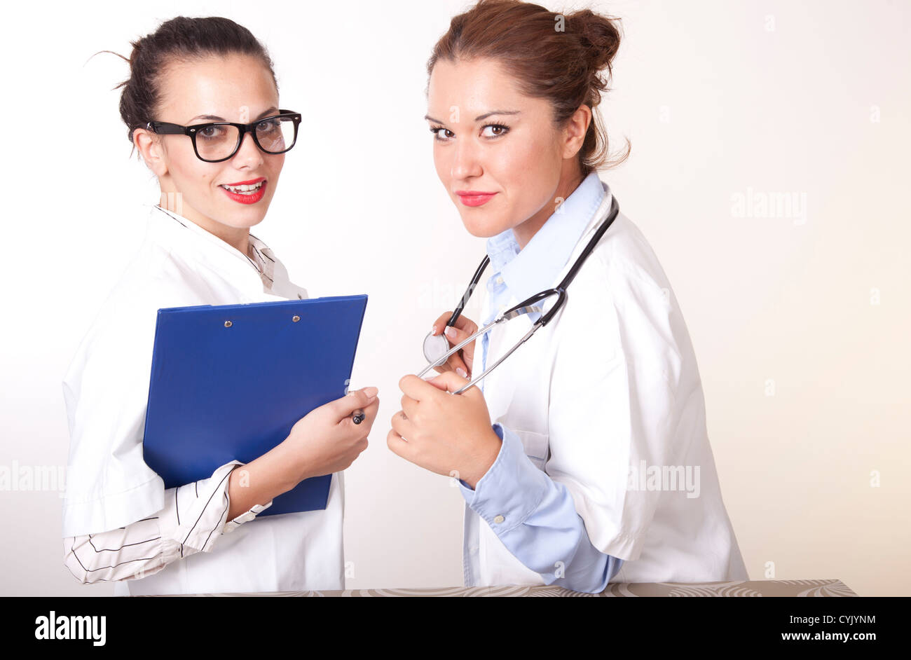 Portrait of a two young beautiful female doctors Stock Photo - Alamy