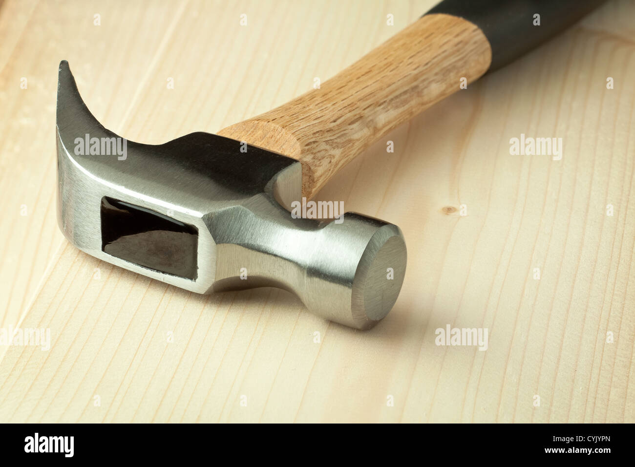 Metal hammer over wooden board Stock Photo - Alamy