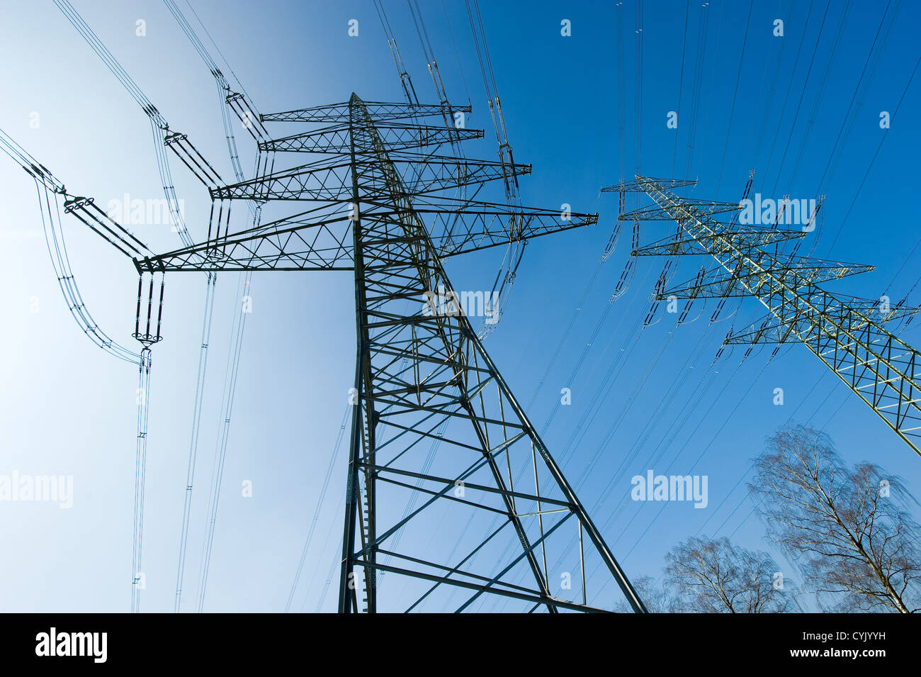 Two electricity pylons with power cables Stock Photo - Alamy