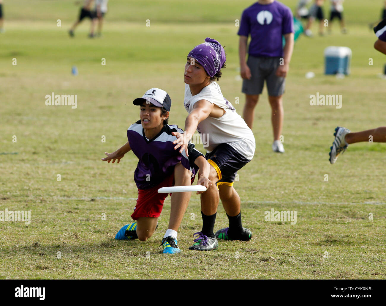 Teenage boy guards his opponent during an Ultimate frisbee game at a ...