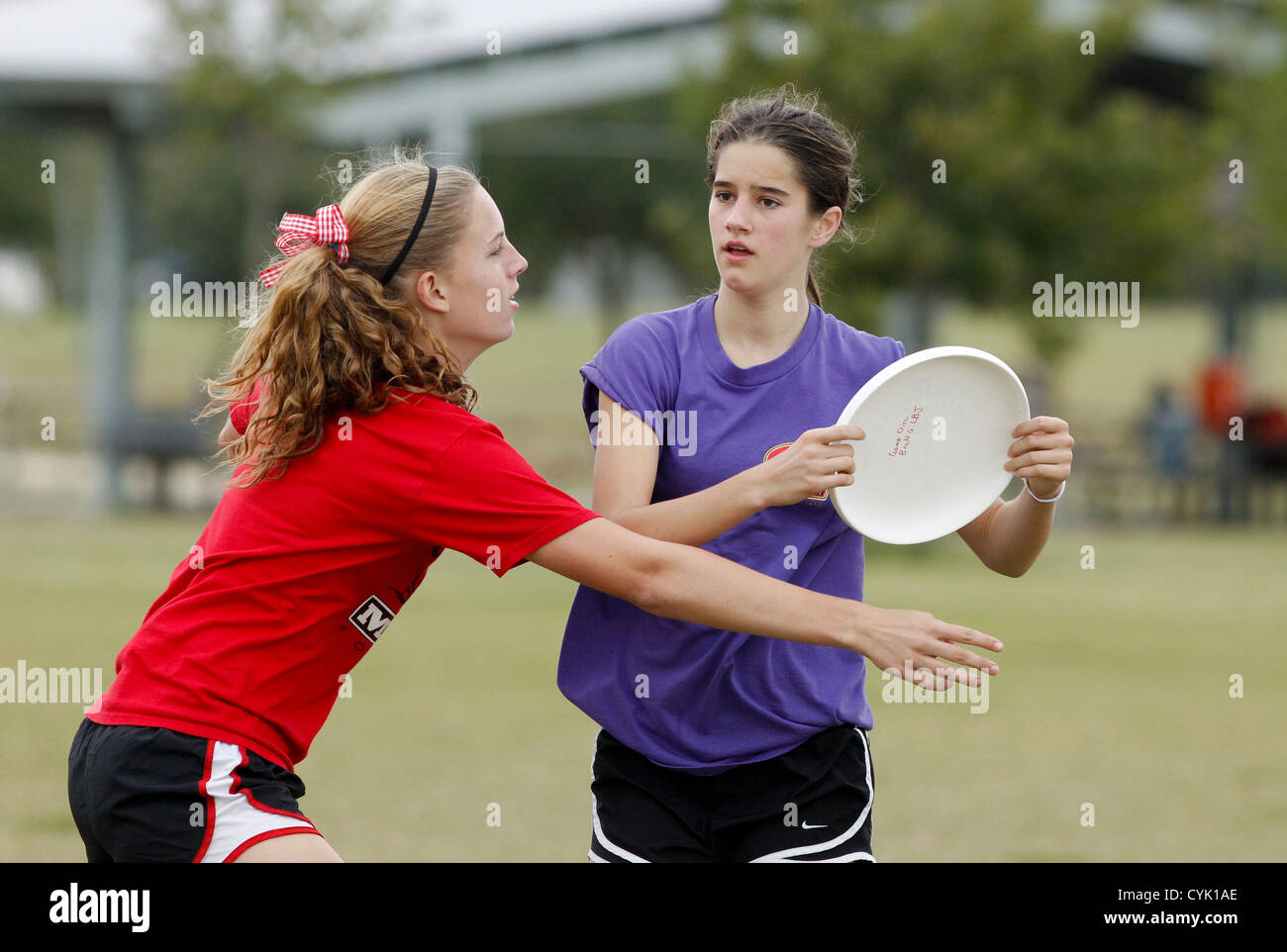 Teenage girl guards her teen girl opponent during an Ultimate Frisbee ...
