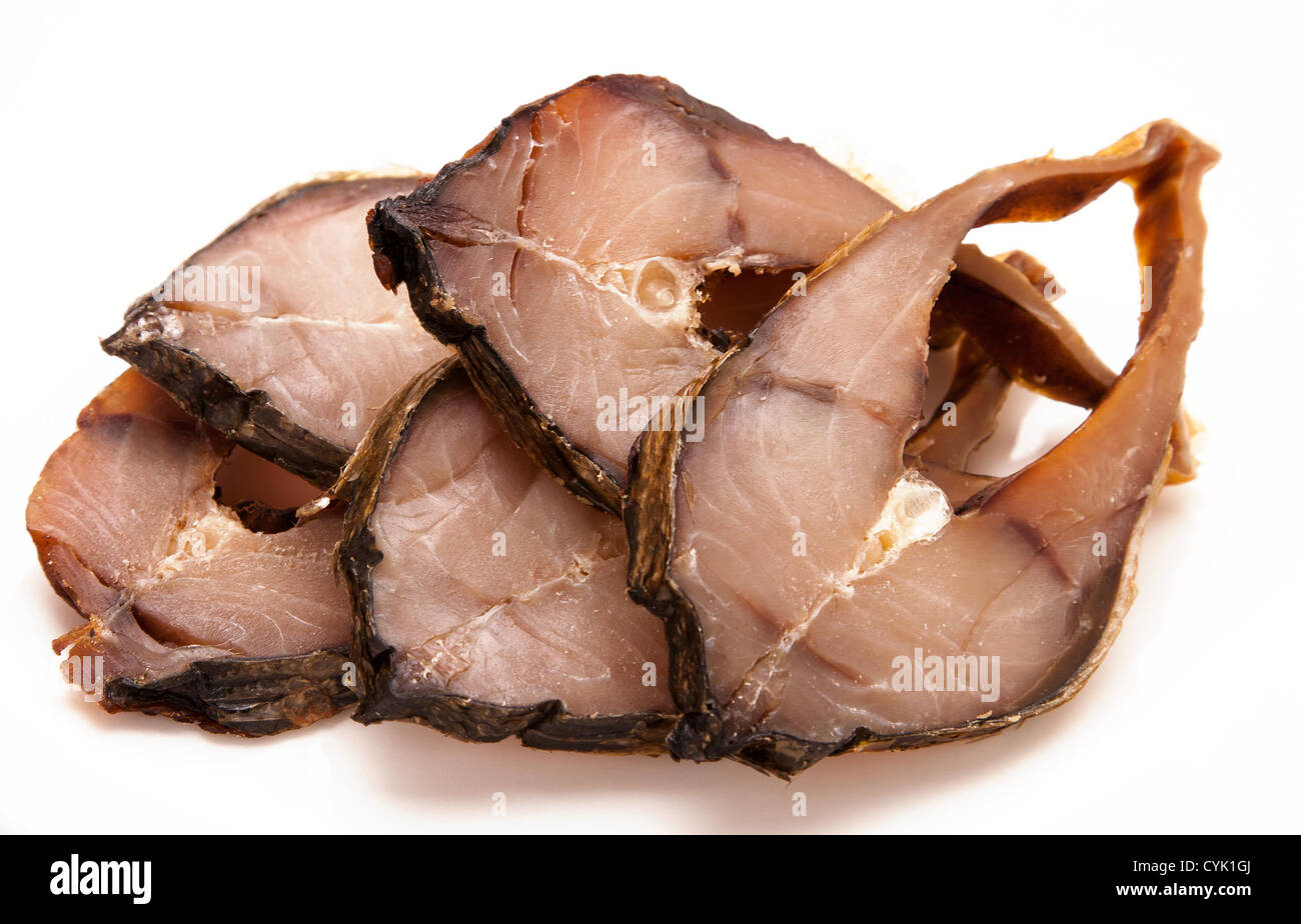 sliced smoked fish on plate on white background Stock Photo - Alamy