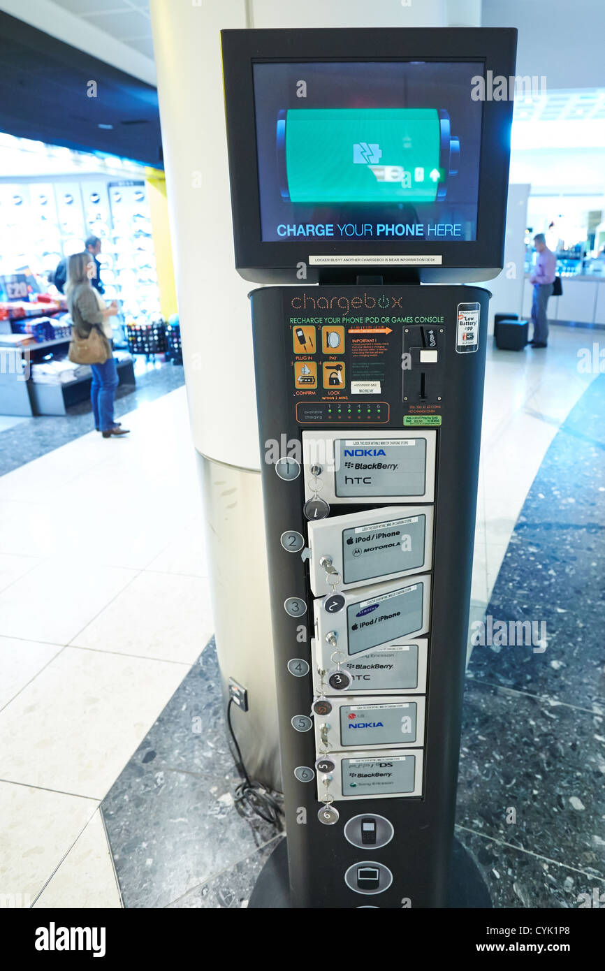 Paid-for mobile phone charging point at Gatwick Airport, London Stock ...