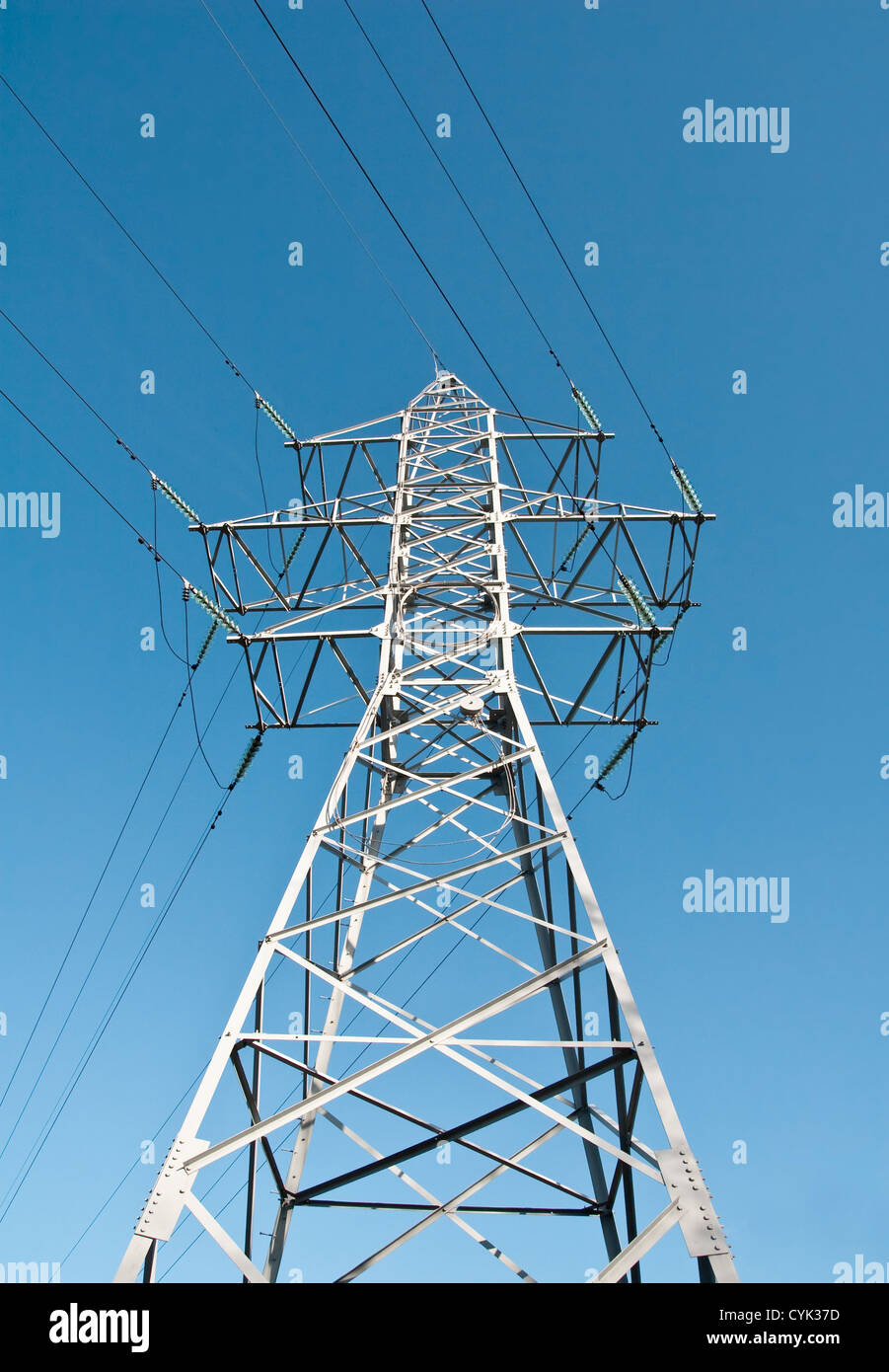 high voltage power supply line on a blue sky background Stock Photo - Alamy