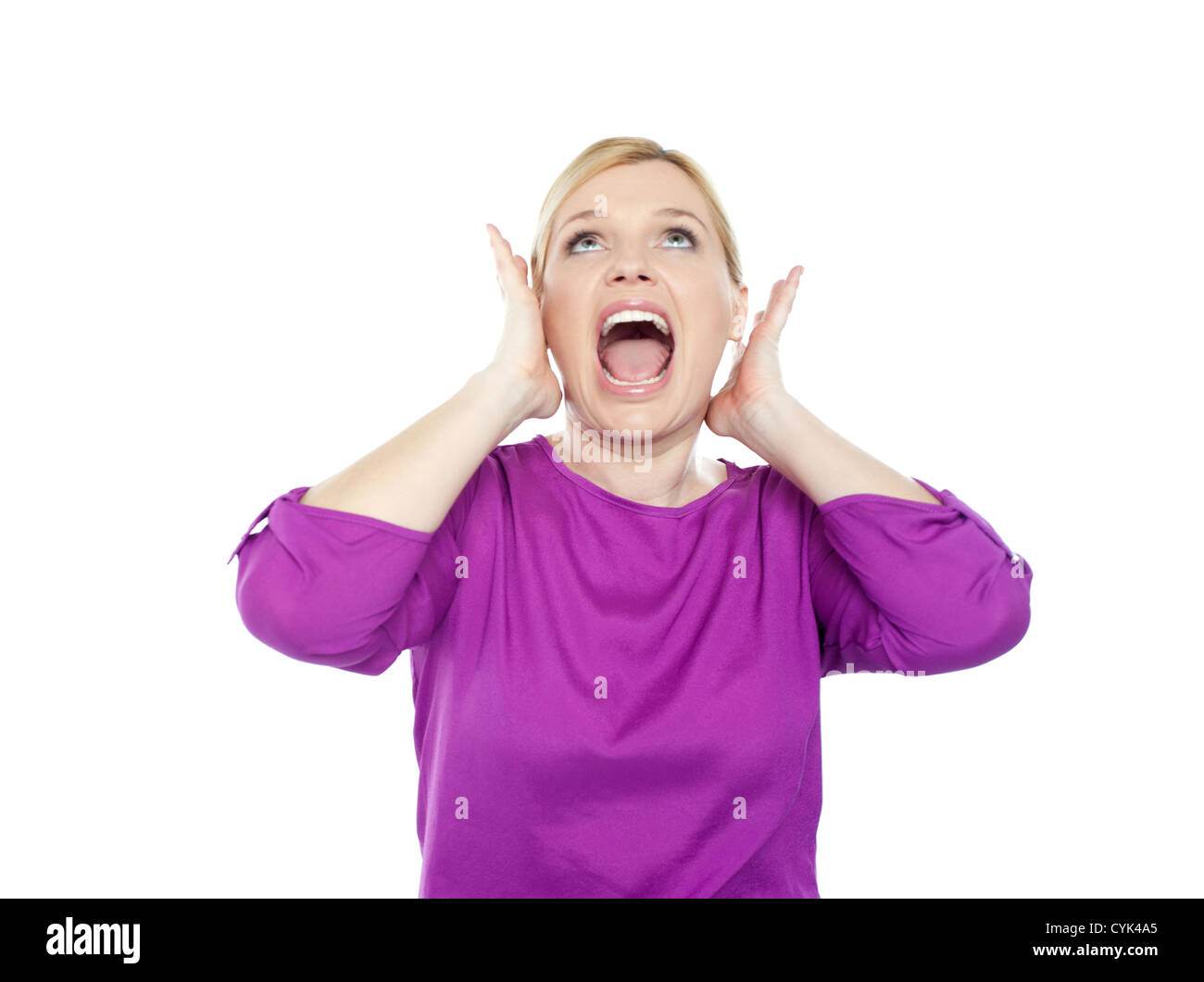 Woman shouting with hands on ears and looking upwards Stock Photo - Alamy