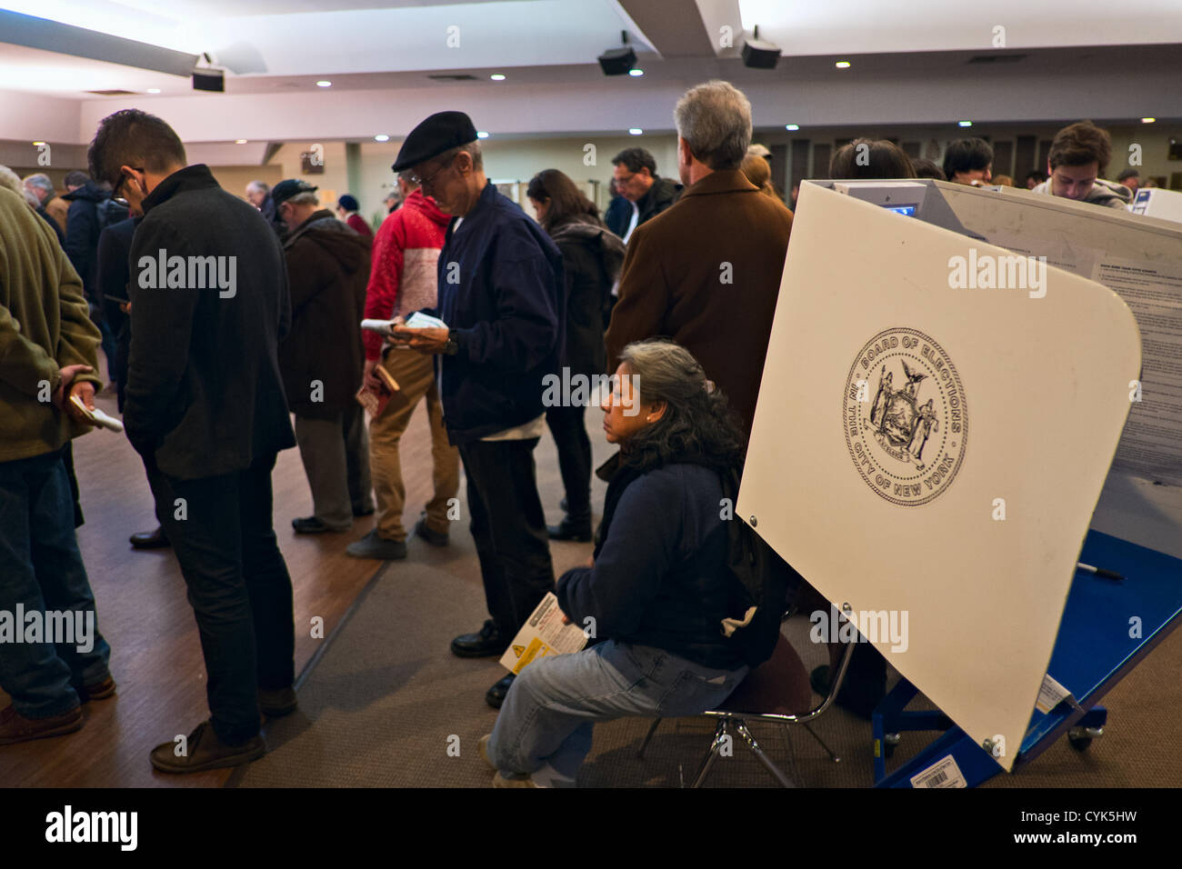 November 6, 2012, Brooklyn, NY, US. Voting booth and people waiting in ...
