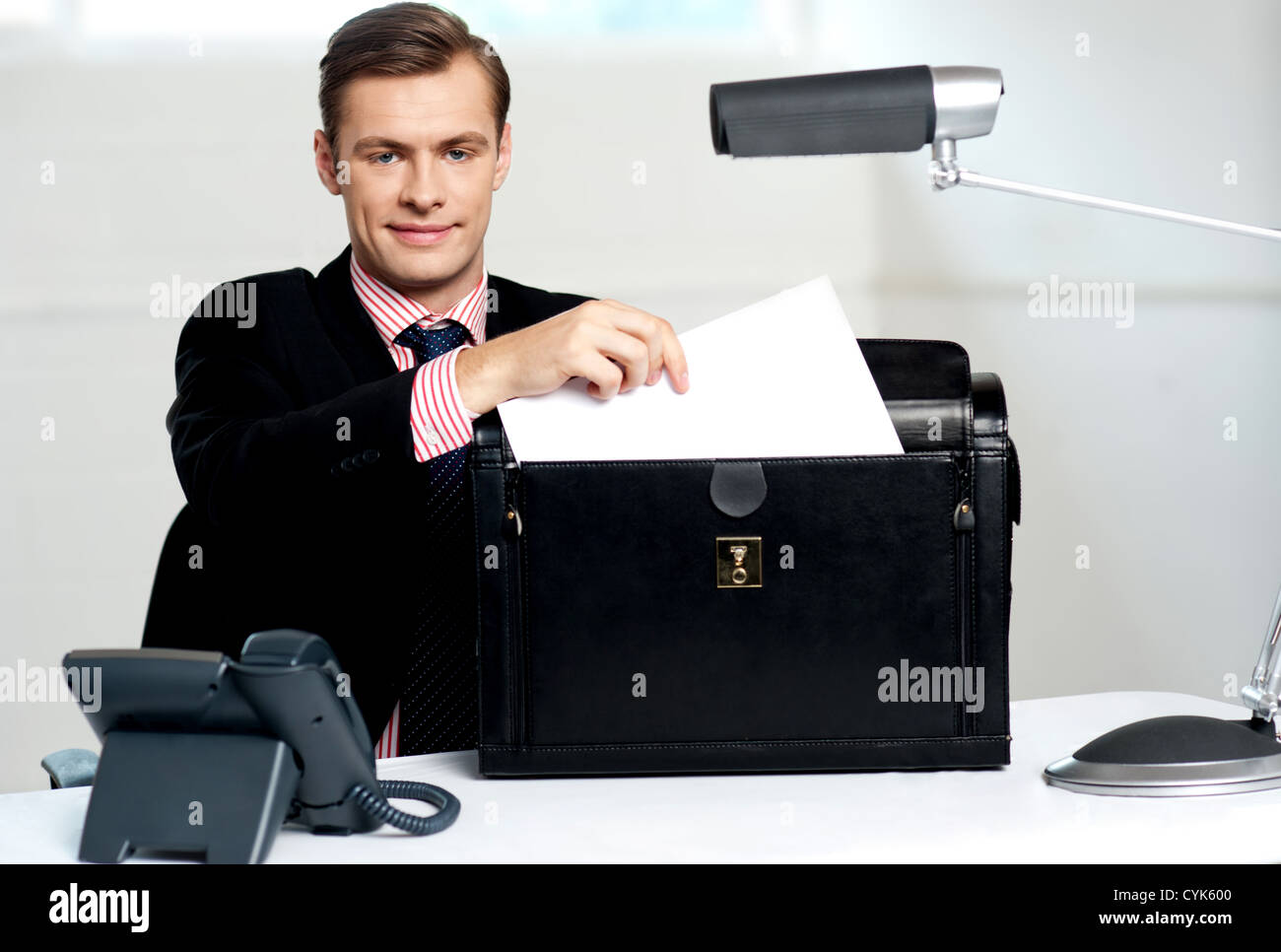 Male executive keeping documents safely in his briefcase Stock Photo ...