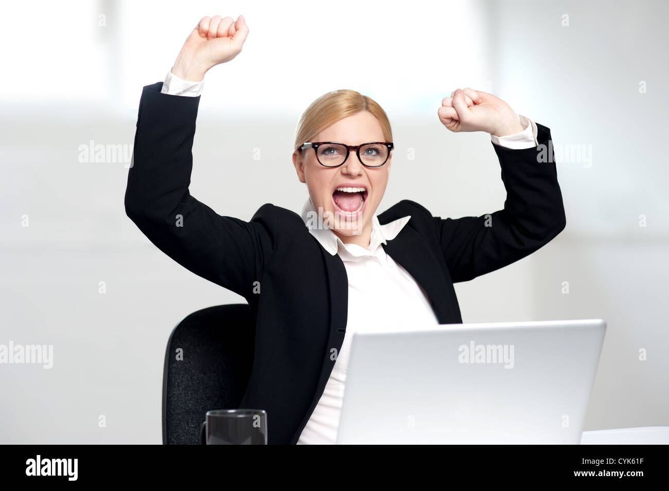 Excited young businesswoman completing looking upwards. Success ...