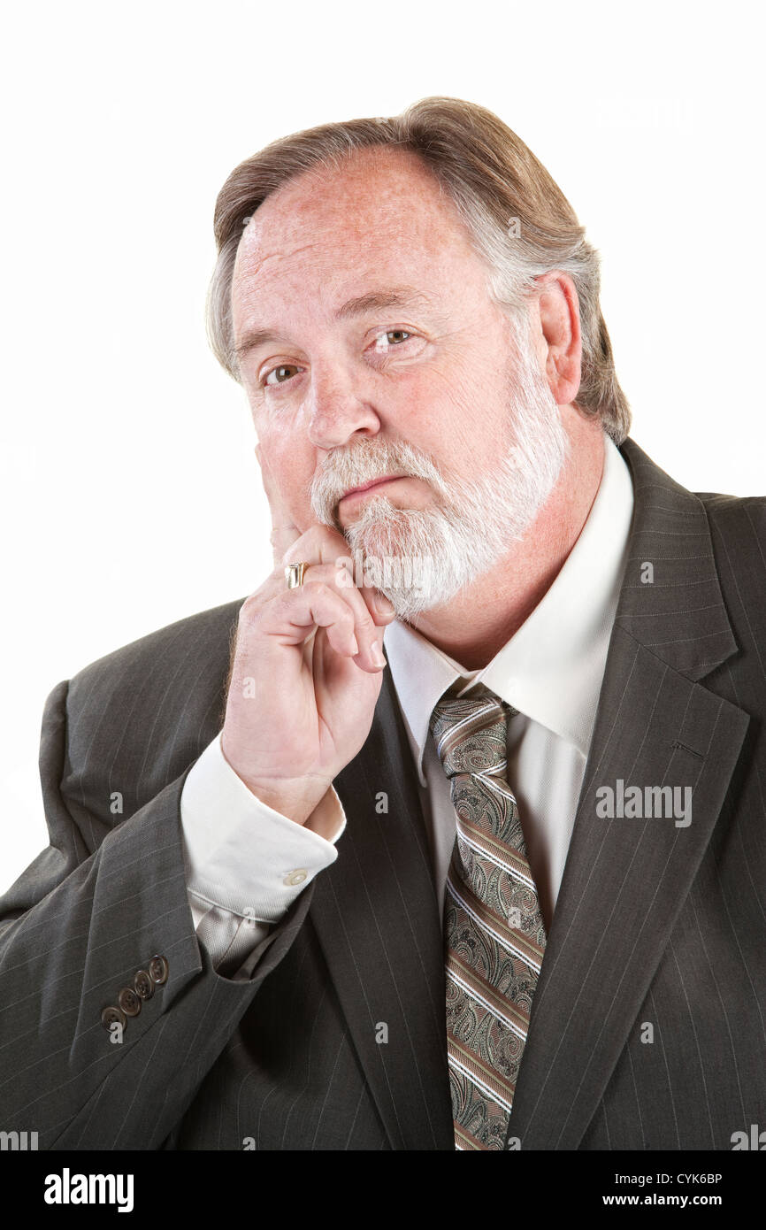 Single mature man with hand on chin Stock Photo - Alamy