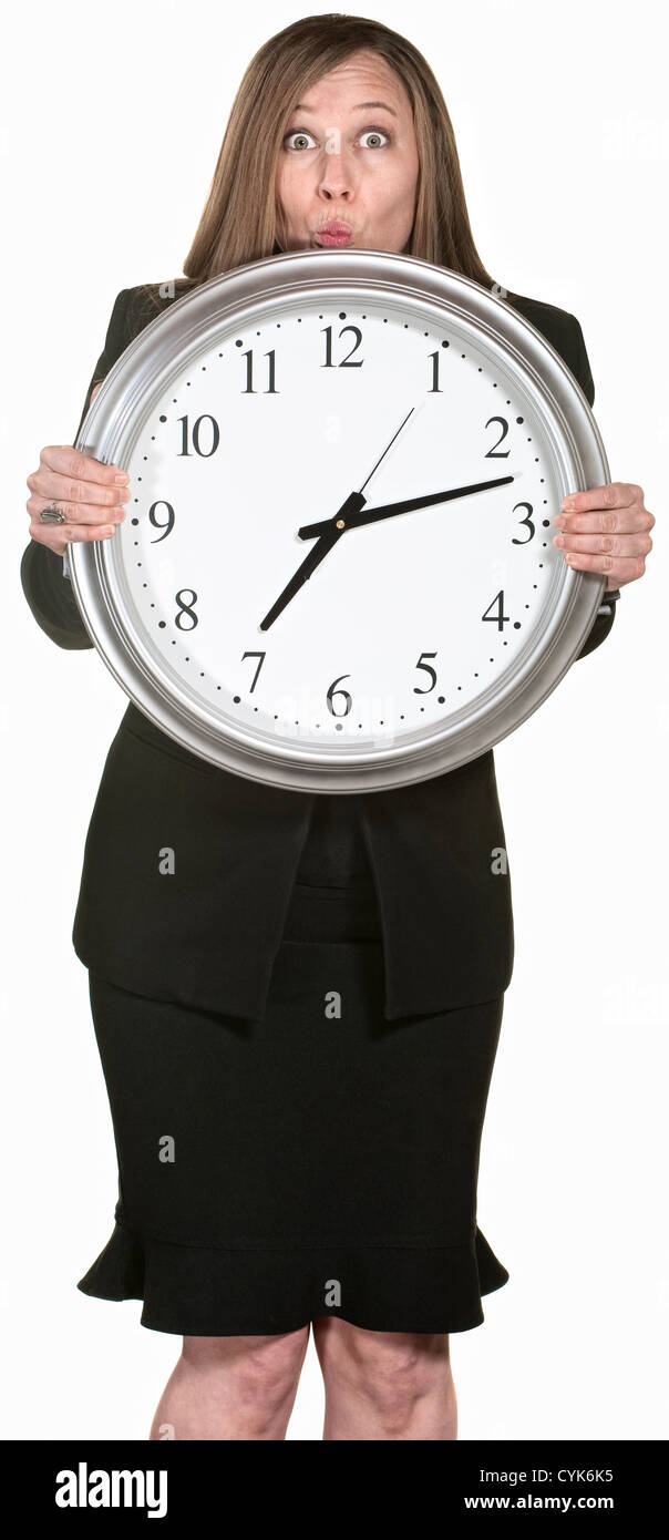 Excited businesswoman behind large clock over white background Stock ...