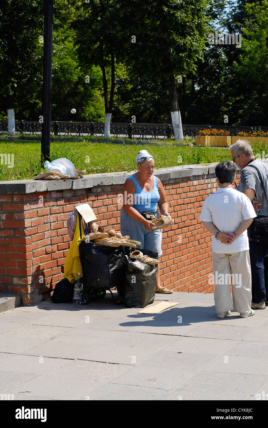 Woman selling traditional shoes on the street Stock Photo - Alamy