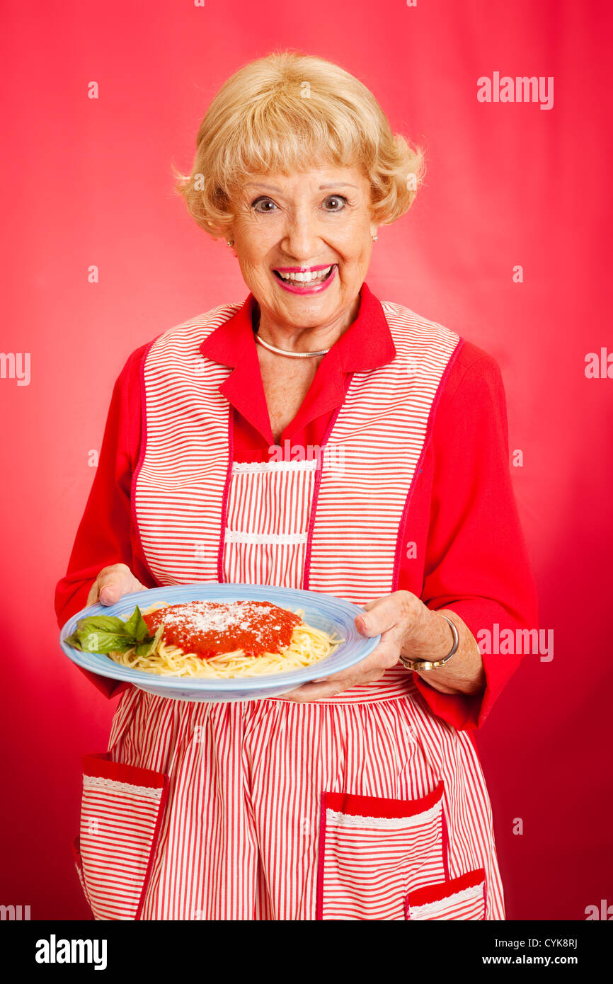 Sweet retro grandmother holding a plate of fresh, hot Italian Spaghetti ...