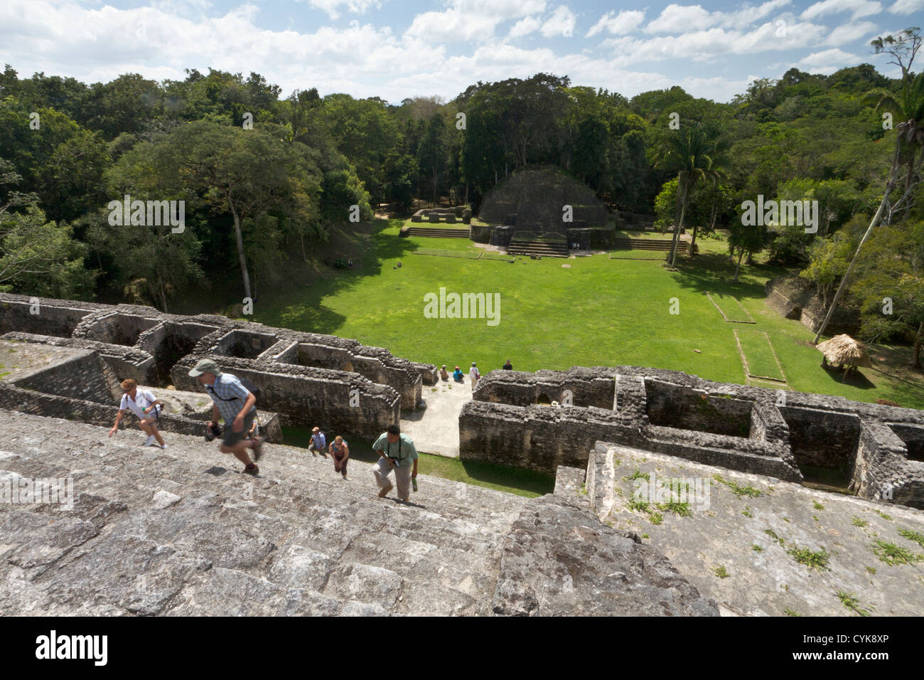 Tourists climb steep steps at Caana pyramid, Caracol ancient Mayan site ...