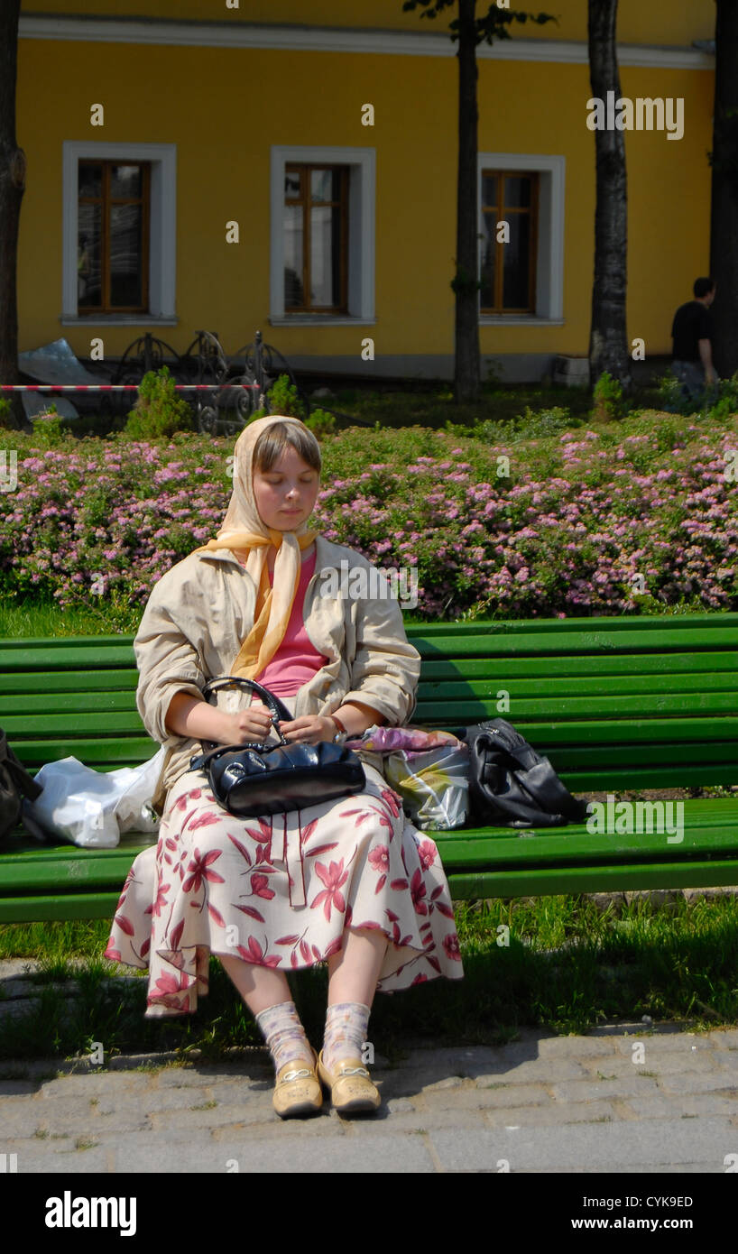 pilgrim sitting bench woman caucasian Stock Photo - Alamy