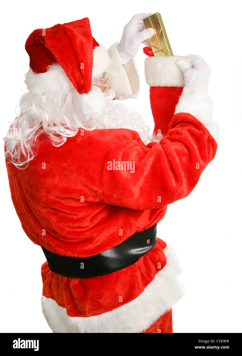 Santa Claus hard at work stuffing stockings for Christmas morning ...