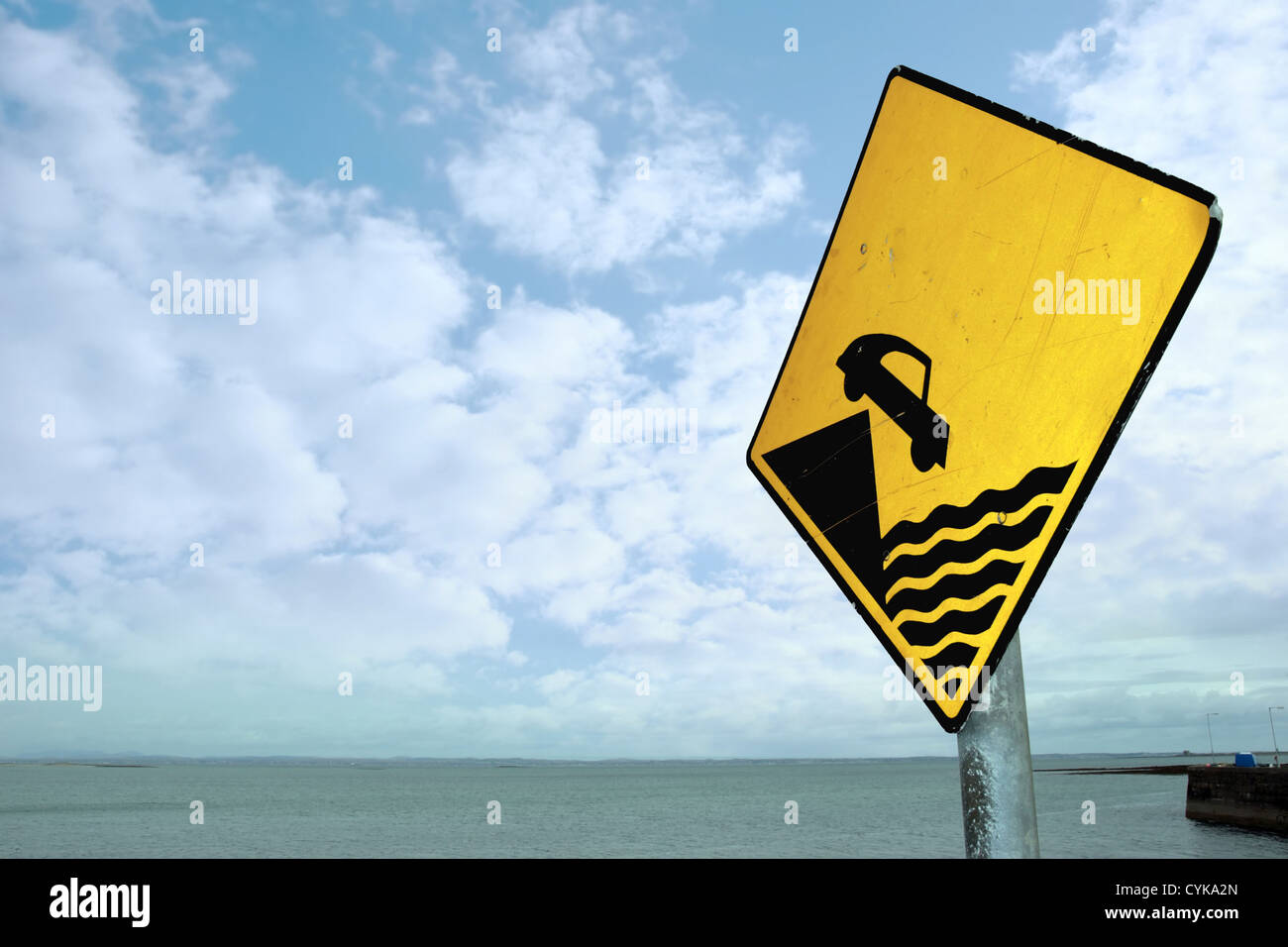 warning sign for drivers to be careful near the waters edge Stock Photo ...