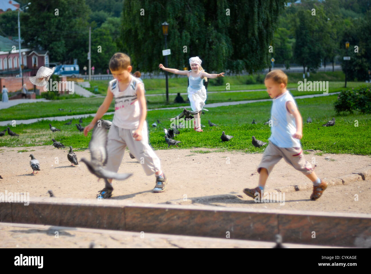 kids playing pigeons bird lots Stock Photo - Alamy
