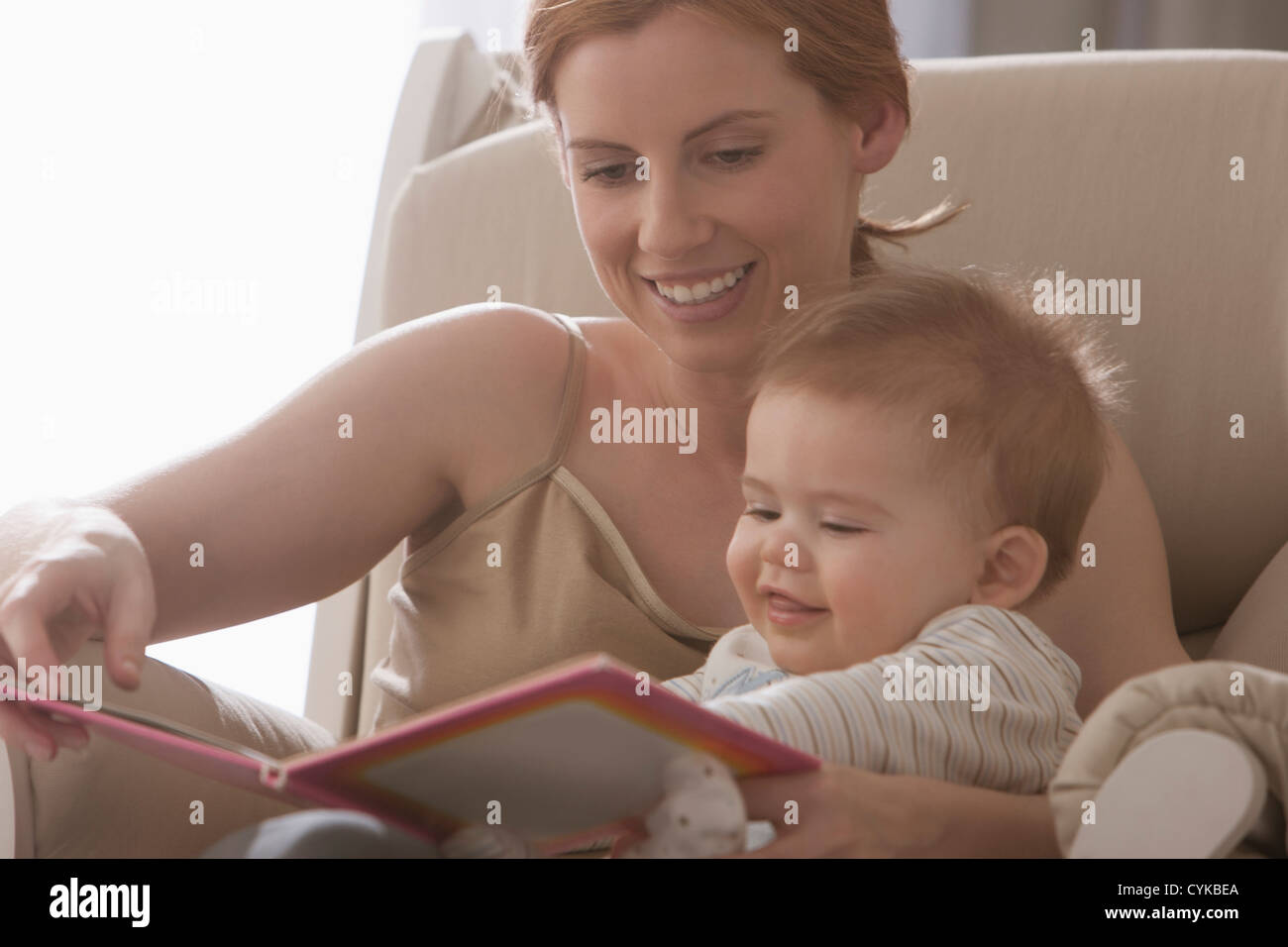 Caucasian mother reading book to son Stock Photo - Alamy