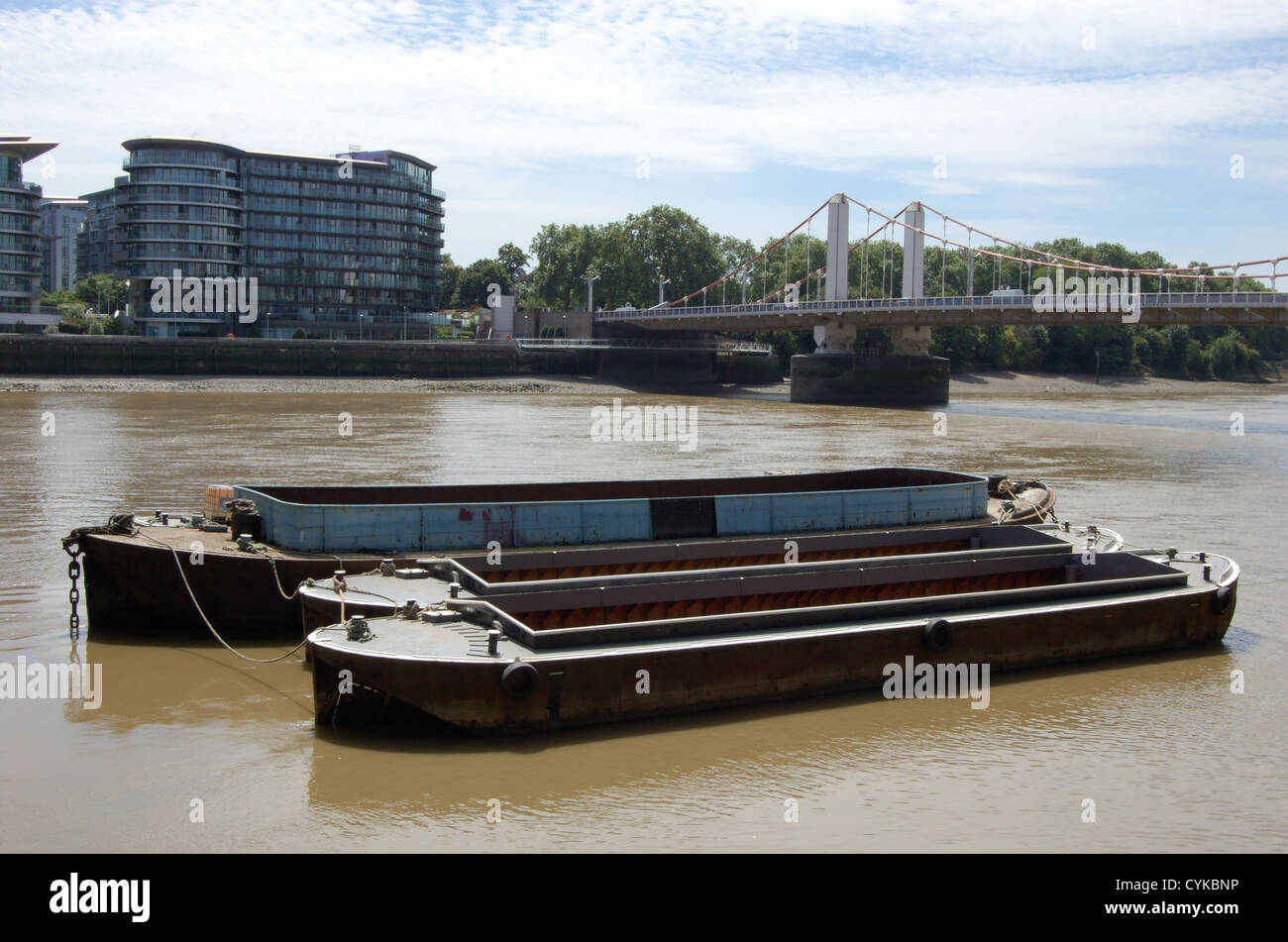 Barges on the River Thames below Chelsea Bridge in London, England ...