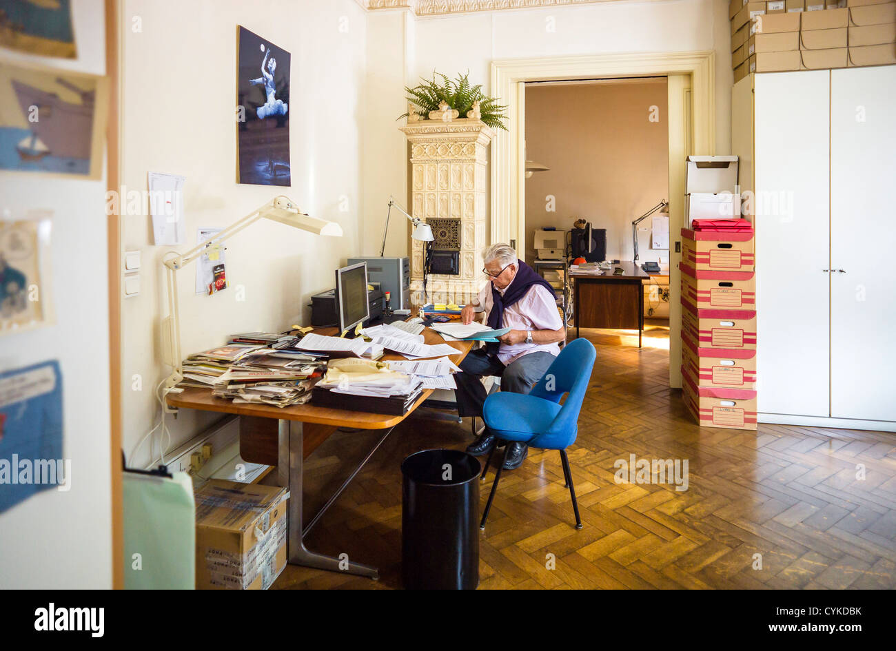 Senior businessman reviewing paperwork in office Stock Photo - Alamy