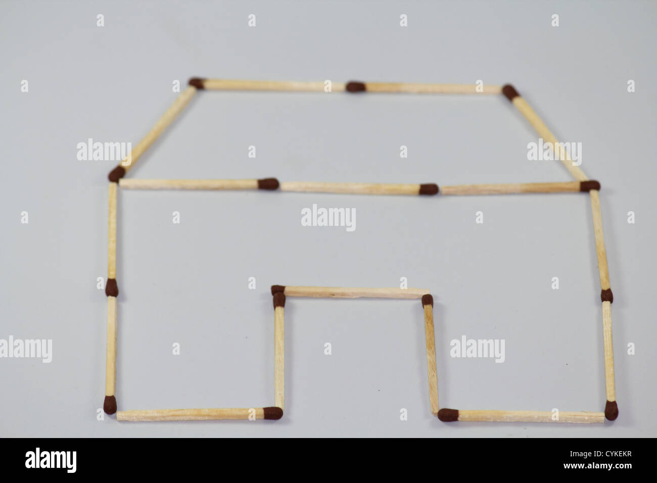 Matches arranged in shape of house Stock Photo - Alamy
