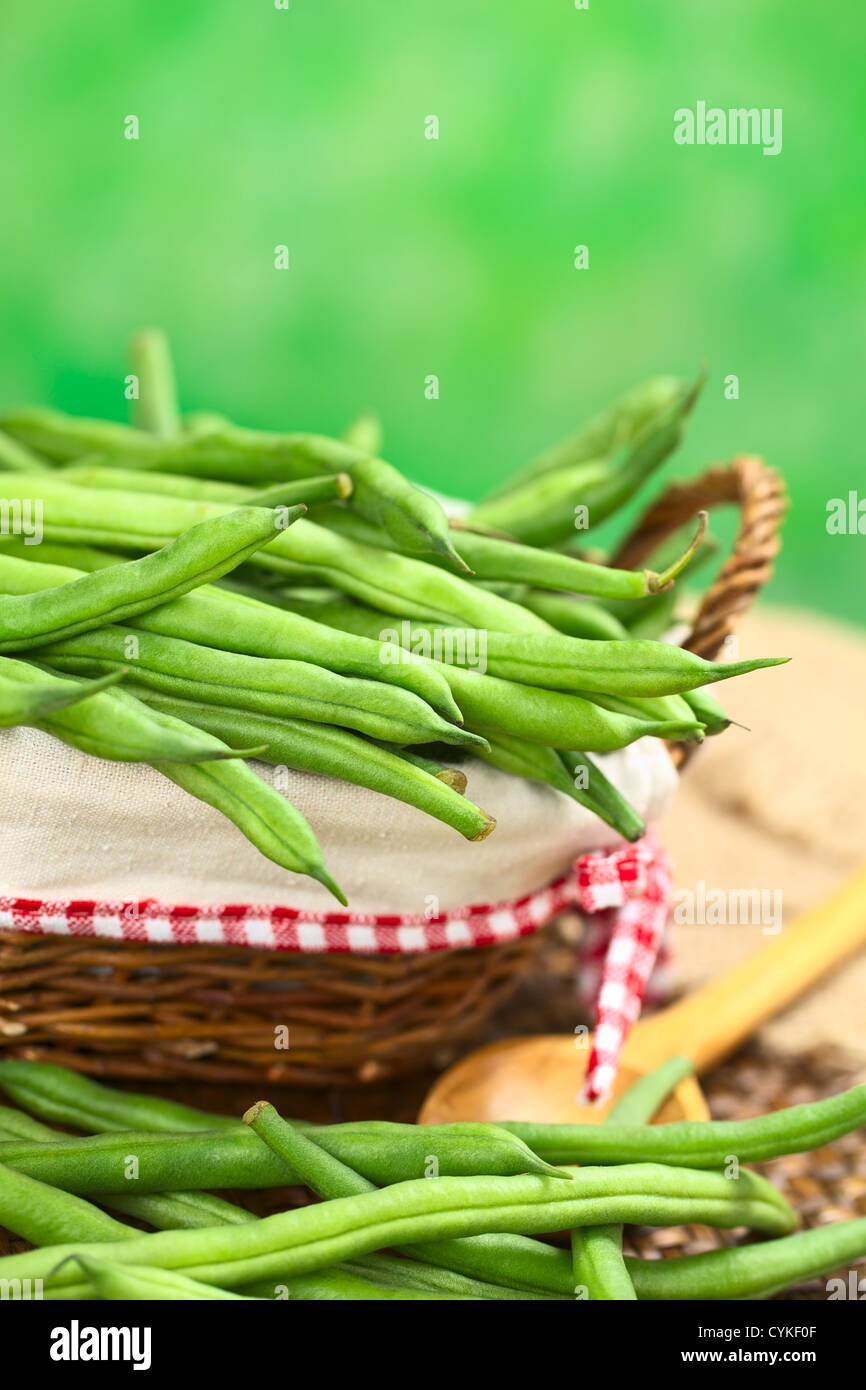 Fresh raw green beans in basket with green background (Selective Focus ...