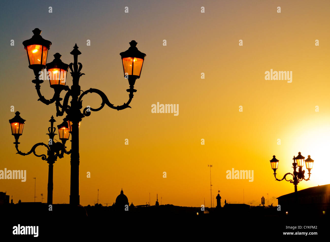Street lights in Rome against the orange sky at sunset Stock Photo - Alamy