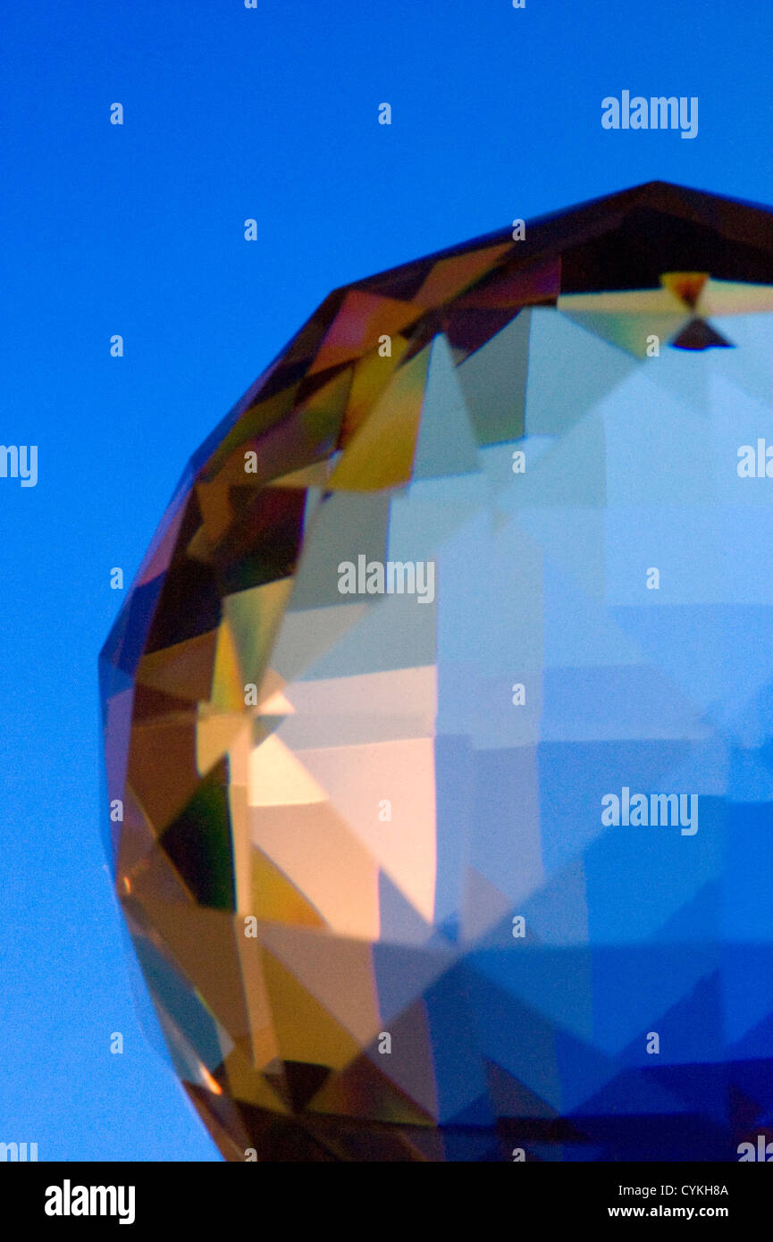A faceted crystal ball reflecting and refracting different lights Stock ...