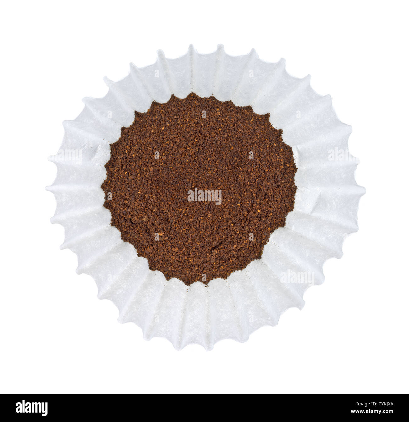 Top view of a white coffee filter with a serving of dry coffee grounds ...
