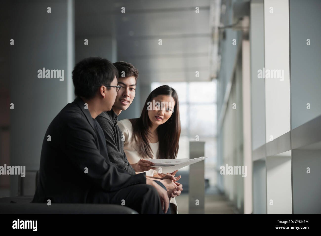 Business people reviewing paperwork Stock Photo - Alamy
