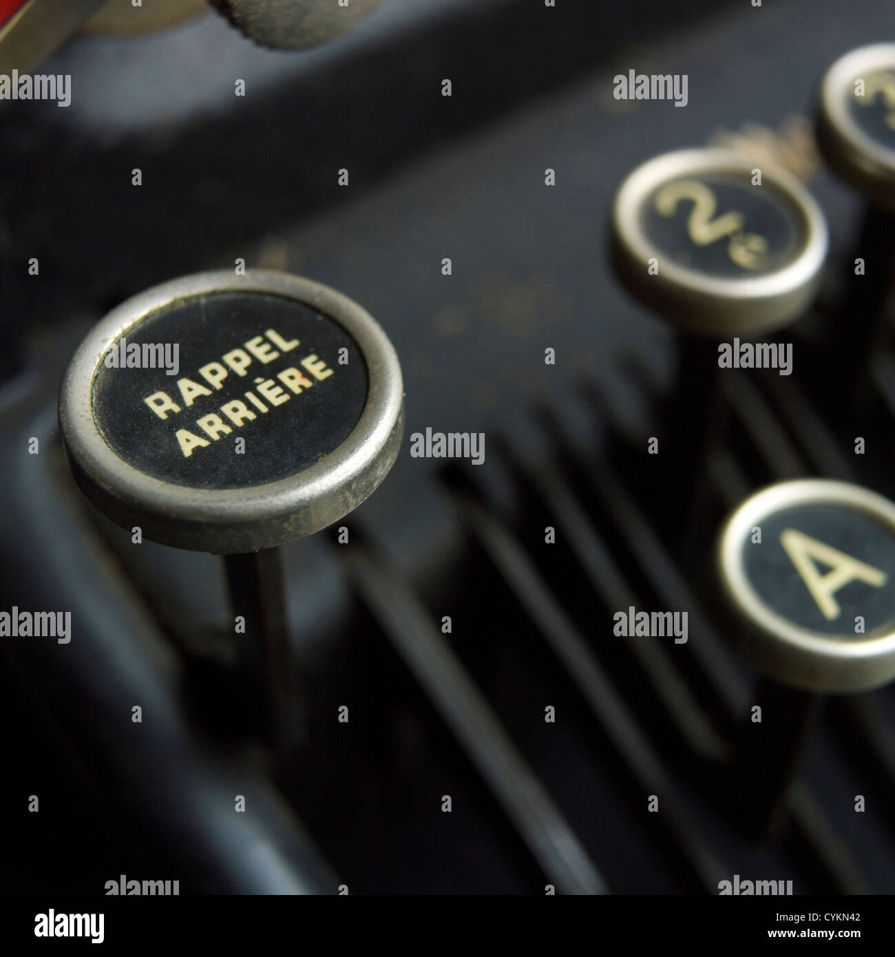 Close-up view of a vintage typewriter key highlighting the French term ...