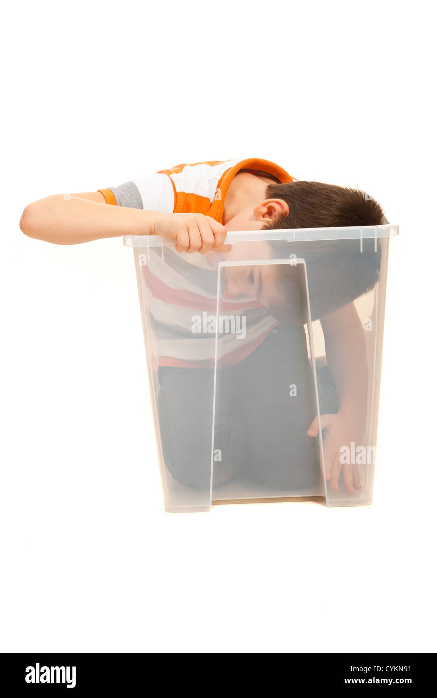 Big boy trying to enter in a transparent box isolated on white ...