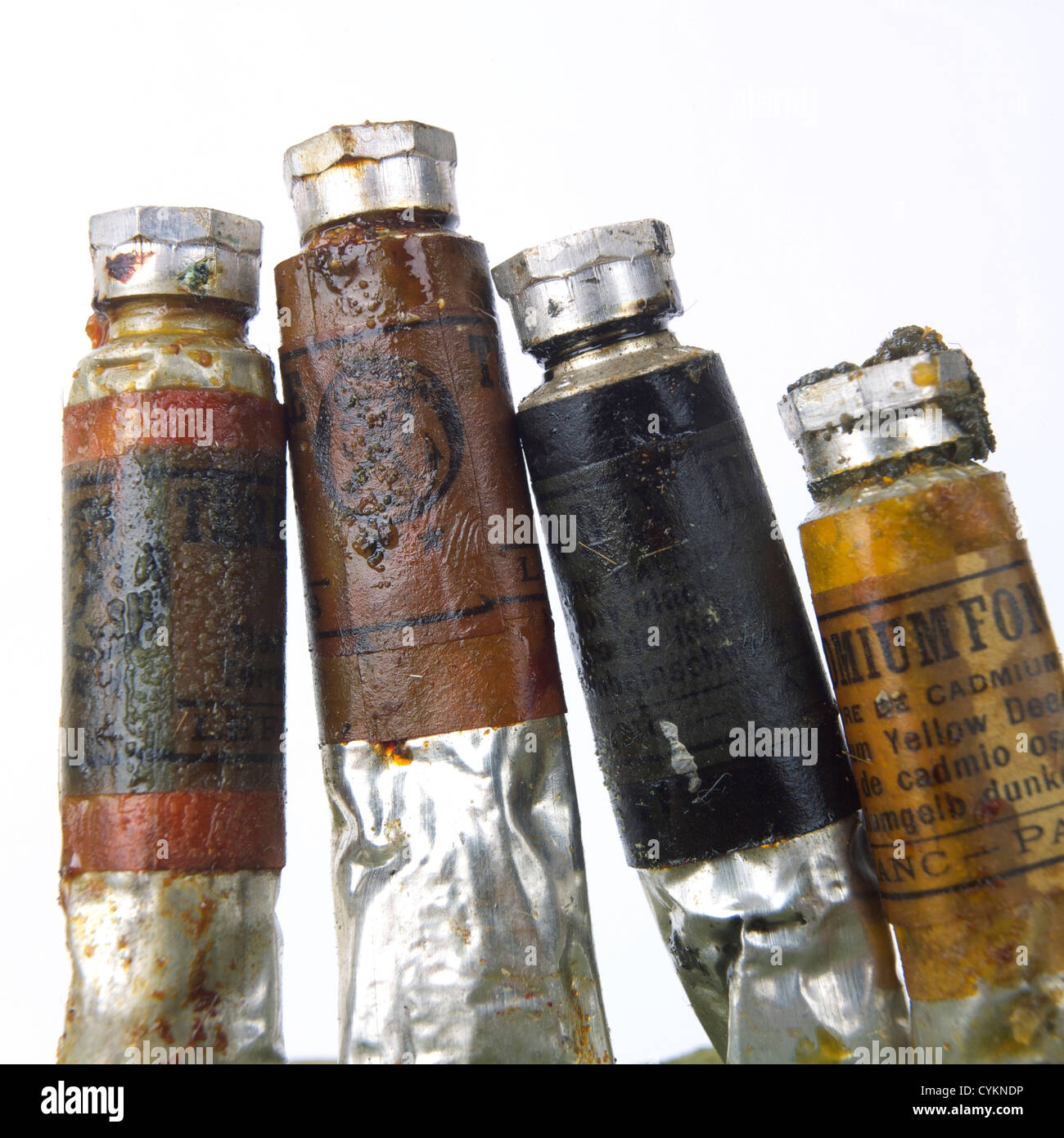 Old paint tubes showing wear and patina with various colors and labels ...