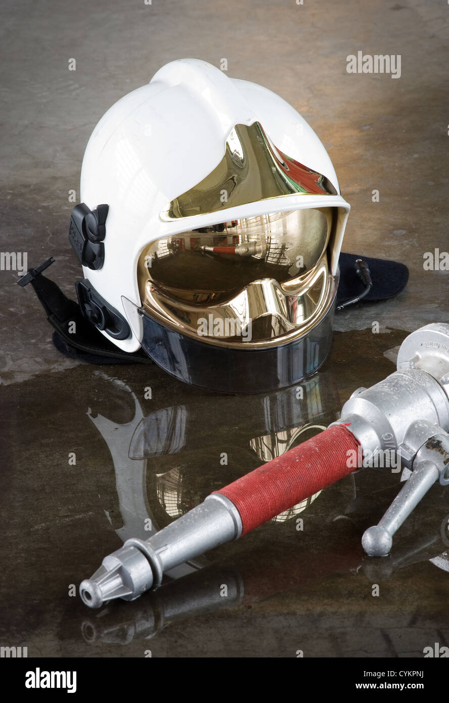 A helmet and a nozzle on the floor in a firestation used by ...