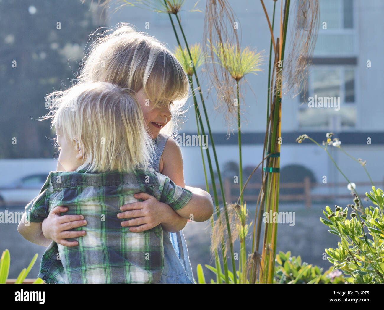 Toddlers hugging outdoors Stock Photo - Alamy