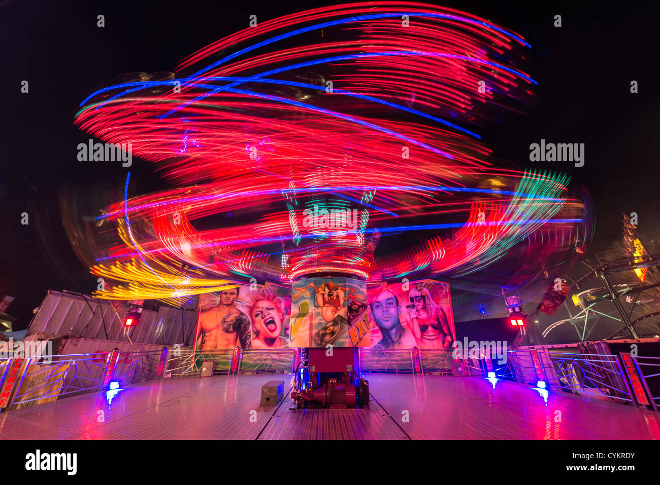 Colorful light trails of the amusement rides at the Royal Show at night ...