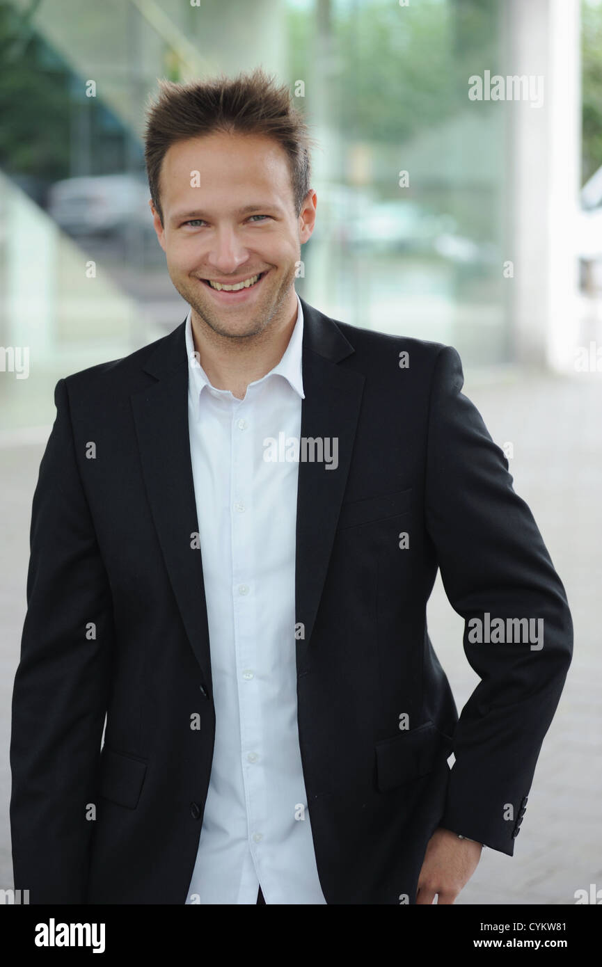 Jolly brunette man smiling standing hi-res stock photography and images ...