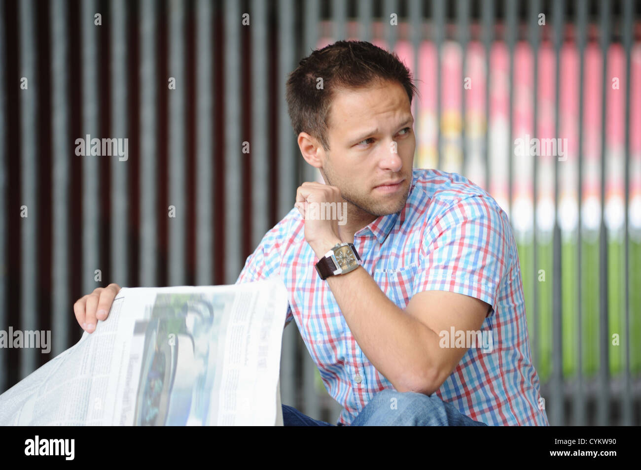 Man reading newspaper outdoors Stock Photo - Alamy