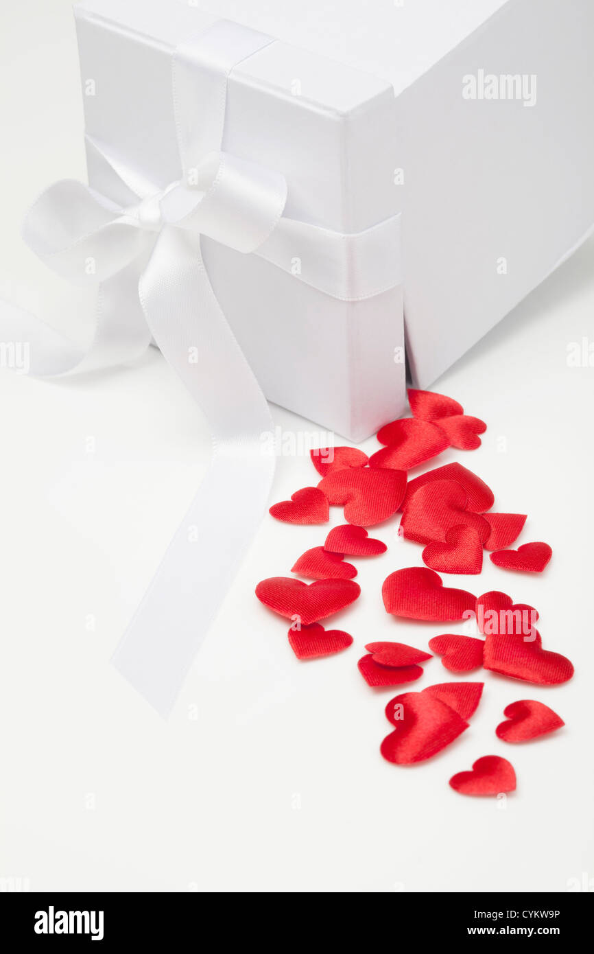 Satin hearts spilling from gift box Stock Photo - Alamy