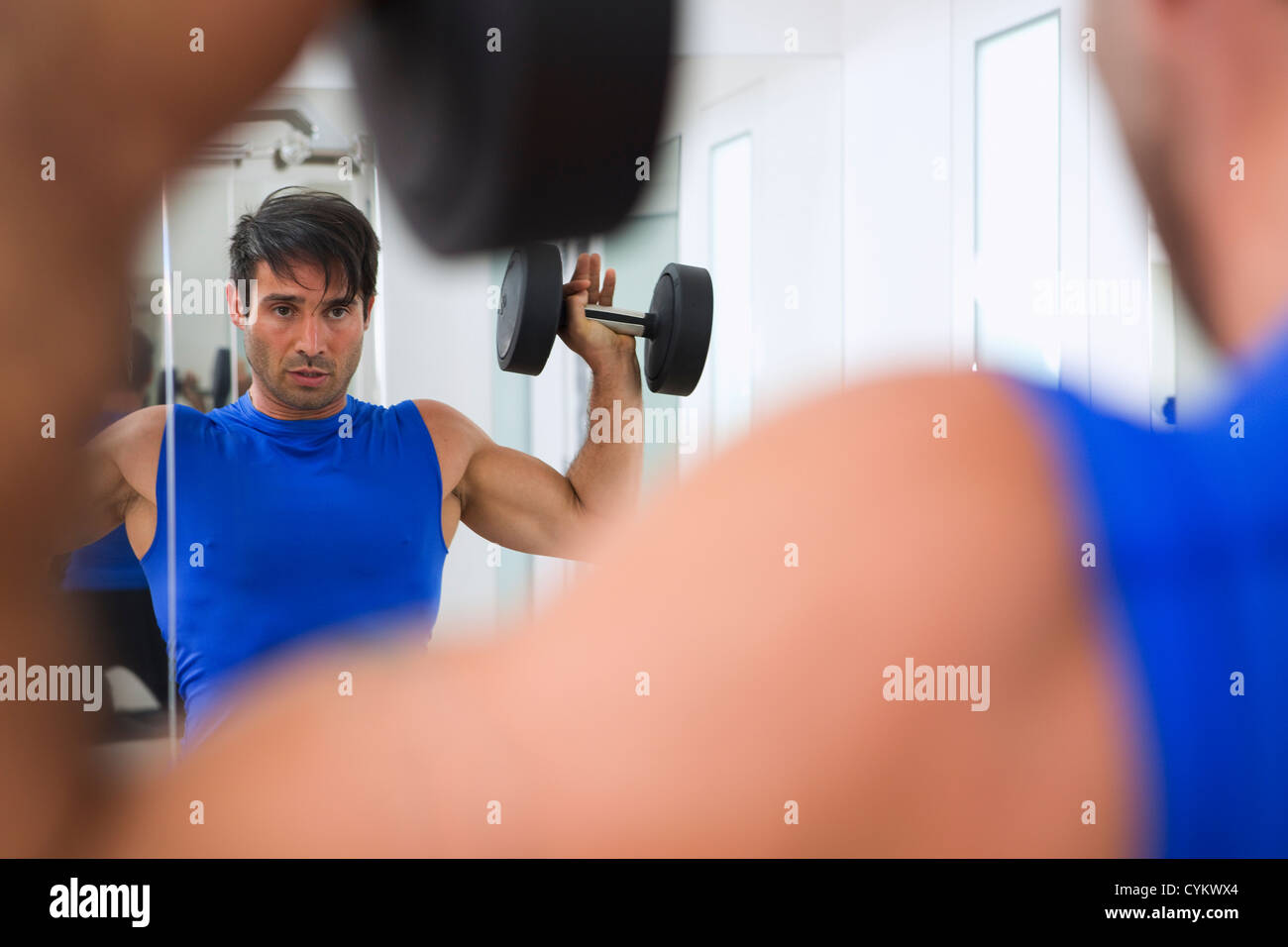 Man lifting weights in gym Stock Photo - Alamy