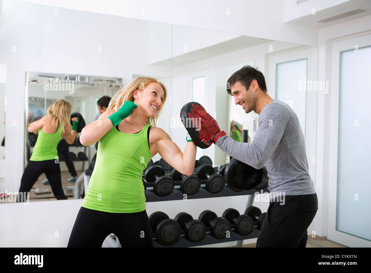 Boxer practicing with trainer in gym Stock Photo - Alamy