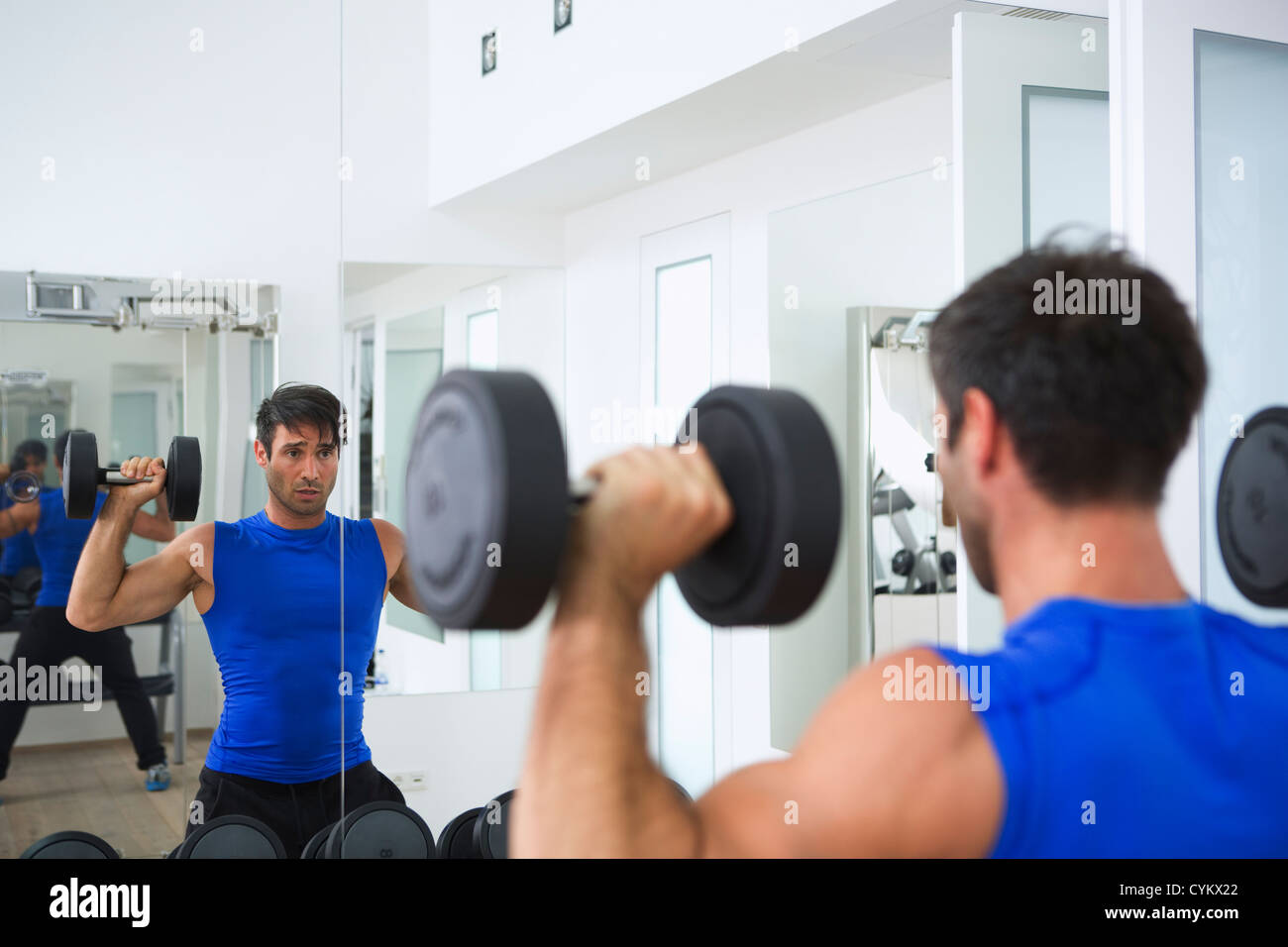 Man lifting weights in gym Stock Photo - Alamy