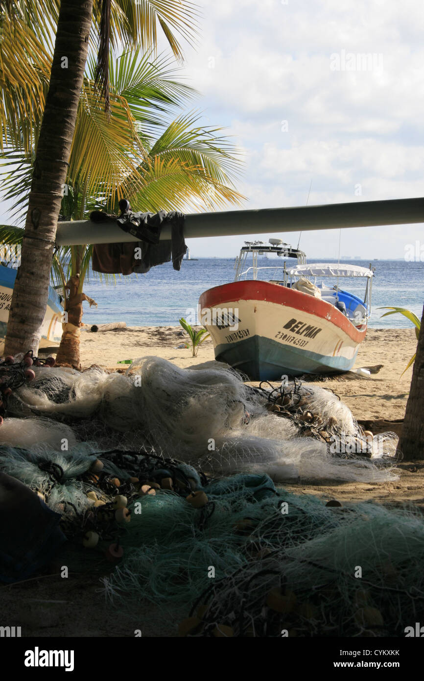 Fishing boat and nets on the beach, Isla Mujeres, Mexico Stock Photo ...