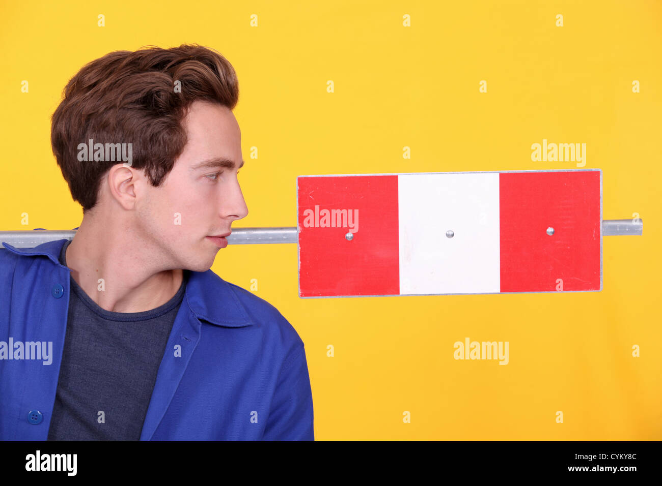 Man stood with road sign in studio Stock Photo - Alamy