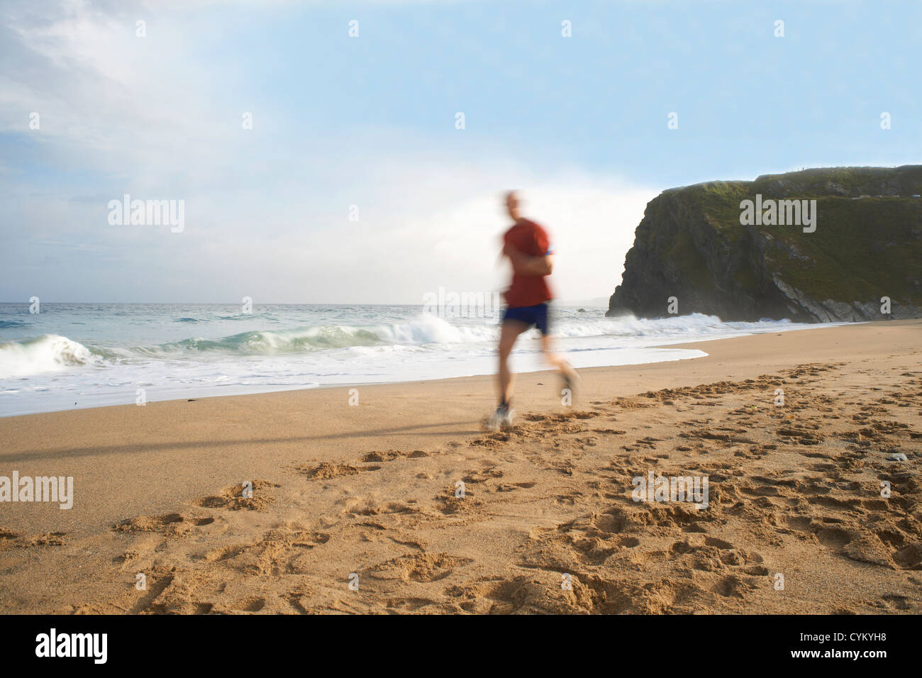 Man running on beach Stock Photo - Alamy