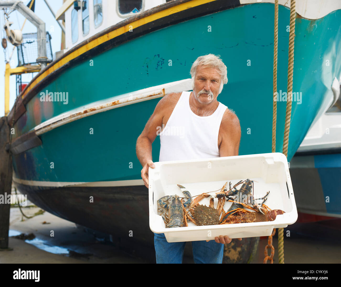 Fisherman holding catch on boat Stock Photo - Alamy